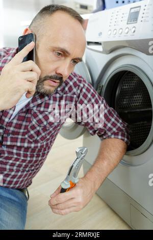 a laundry room with a washer and dryer next to the shower stall in ...