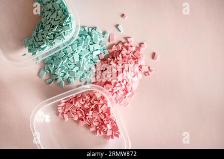 A pile of plastics - small pieces of hard plastic, pink and blue color ...