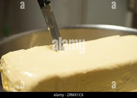 Butter block in the bit bowl, with a knife on top Stock Photo - Alamy