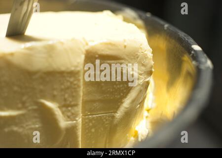 Butter block in the bit bowl, with a knife on top Stock Photo - Alamy