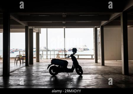 A moped stands alone in an empty restaurant on Walking St. Pattaya ...