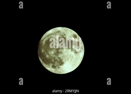 Baghdad, Iraq. 30th Aug, 2023. A man takes a photo of a full moon in ...