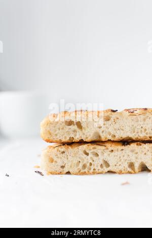 Cross section of homemade onion focaccia on a white background,sliced ...