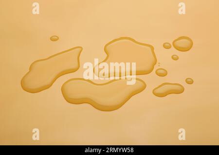 Puddle of water on pale orange background Stock Photo - Alamy