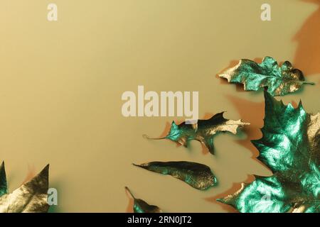Metallic gold autumn leaves with copy space on orange background Stock ...