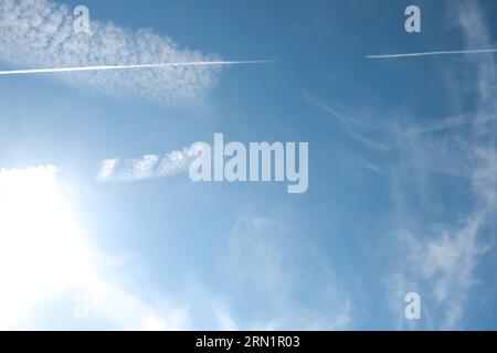 Cirrus clouds and long airplane trail row. Aero plane contrail in blue ...