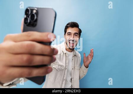 Portrait of a brunette man animate and joyful looking on the phone ...