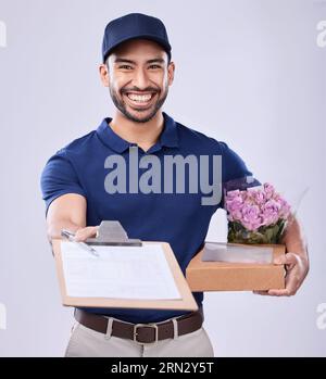 Happy young delivery man with bouquet of beautiful tulips on grey ...