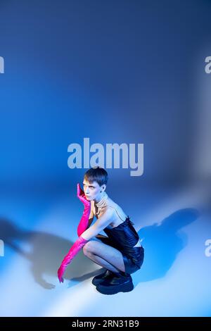 elegant nonbinary person in black beret pointing with finger while ...