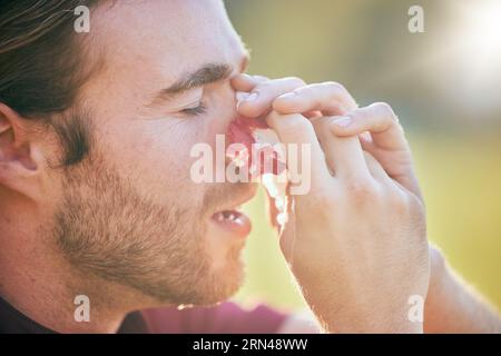 Nose bleed, man closeup and sports injury closeup on field with ...