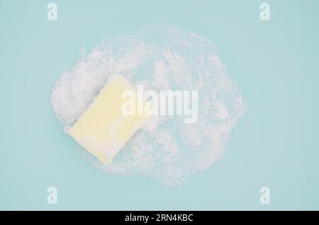 overhead view sponge with sud blue background Stock Photo - Alamy