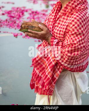 man devotee with religious offerings for sun god during Chhath festival ...