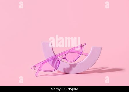 Decorative podium with stylish sunglasses on pink background Stock ...