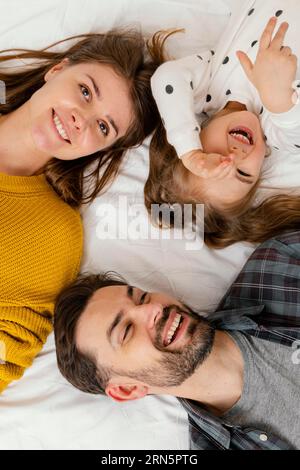 Close up smiley family bed Stock Photo - Alamy