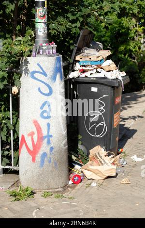 Overfilled dustbin for residual waste standing on the street, Germany ...