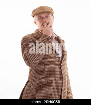 A mature Englishman in classic tweeds smoking a large cigar Stock Photo ...
