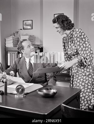 Old boss and his assistant working in the office Stock Photo - Alamy