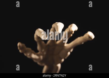Plastic skeleton hand with copy space on black background Stock Photo ...