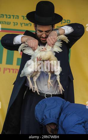 An ultra Orthodox Jewish woman waves a chicken over her head during the ...