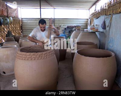 (151004) -- BAGHDAD, Oct. 4, 2015 -- Abu Ibrahim makes pottery jars at ...