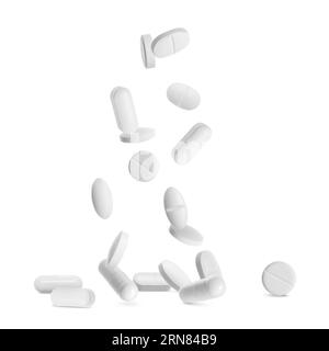 Many different pills falling on white background Stock Photo - Alamy