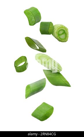 Cut green onion falling on white background Stock Photo - Alamy
