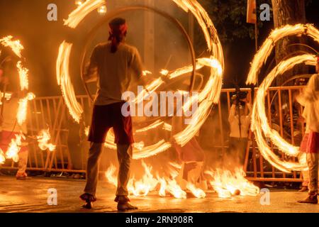 Kandy, Homagama, Sri Lanka. 30th Aug, 2023. A fire spinner takes part ...