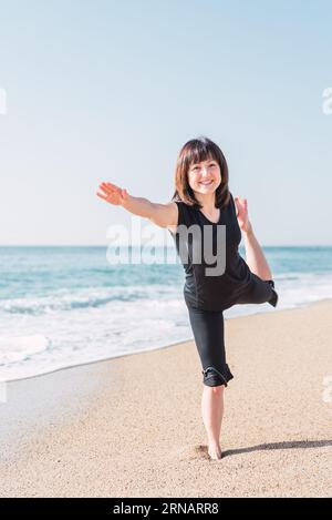 Woman doing yoga asana Natarajasana outdoors at waterfall Stock Photo ...