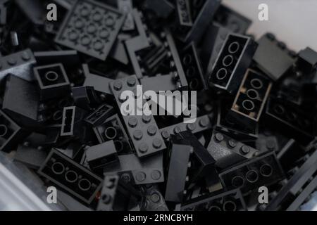 A collection of black building blocks legos on an acrylic box Stock ...