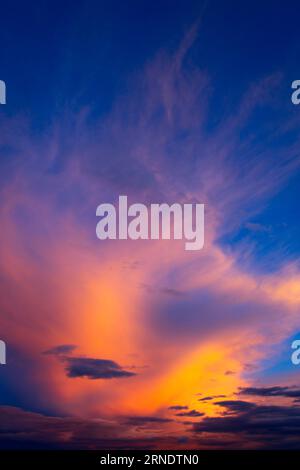 Cumulus clouds and different color tones in the sky at sunset. Dance of ...