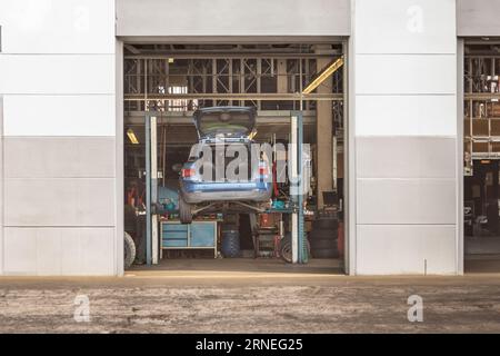Cars lifting in maintenance at garage service station Stock Photo - Alamy