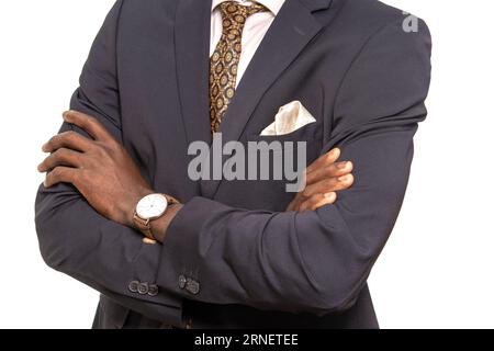 An interracial African ethnicity boss standing with crossed arms in ...