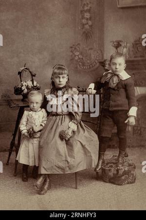 A 19th century photography studio portrait of well-dressed American ...