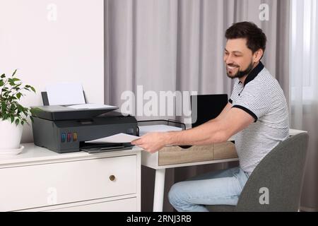 Man using modern printer at workplace indoors, closeup Stock Photo - Alamy