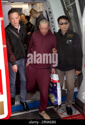 Police officers escort a suspect from the clinic of Doctor Wong Ping ...