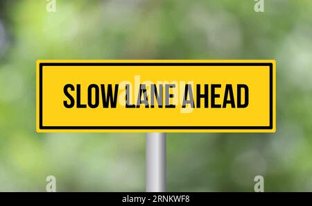 Slow lane ahead road sign on cloudy sky background Stock Photo - Alamy