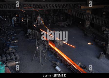 Pakistani laborers work at an iron factory on the eve of International ...