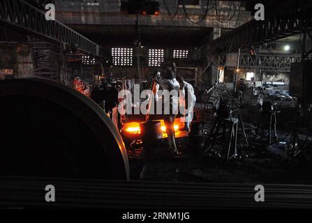 Pakistani laborers work at an iron factory on the eve of International ...