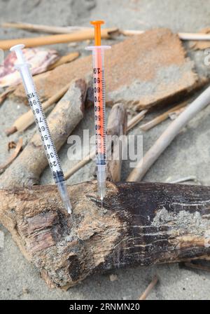 two used syringes abandoned near the beach and the risk of getting ...