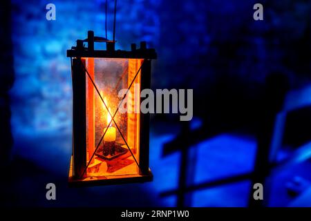 Lantern with candle light inside on wooden bridge in the beach at blue ...