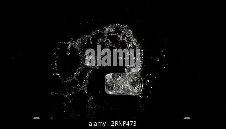 Glass of Water Bouncing and Splashing on Black Background Stock Photo ...