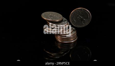 Quarter Dollar Coins Falling, Rolling and Sliding on Black Background ...