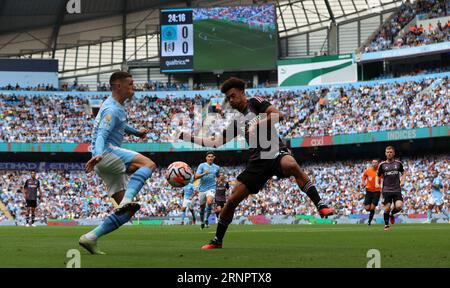 Phil Foden of Manchester City competes for the ball with Morgan Gibbs ...