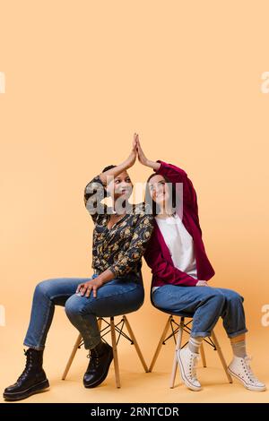 Two best friends high fiving on the beach Stock Photo - Alamy