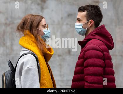 Side view couple wearing medical masks Stock Photo - Alamy