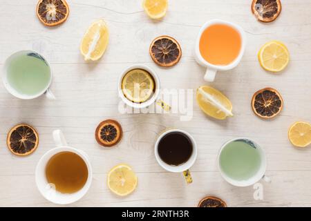 Various types tea ceramic cup dry grapefruit slices with lemon wooden ...