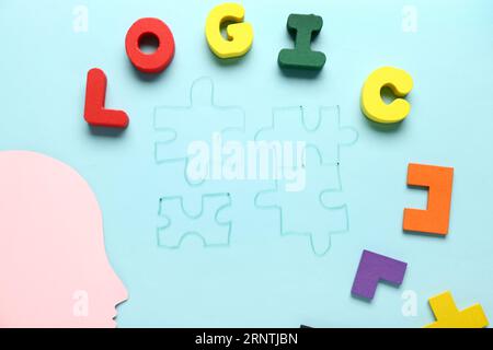 Word LOGIC with drawn puzzle pieces, blocks and paper human head on ...