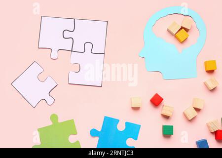 Paper human head with cubes and puzzle pieces on pink background. Logic ...