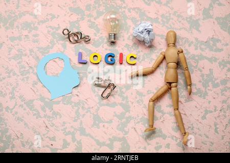 Word LOGIC with toys, paper human head and light bulb on grunge ...