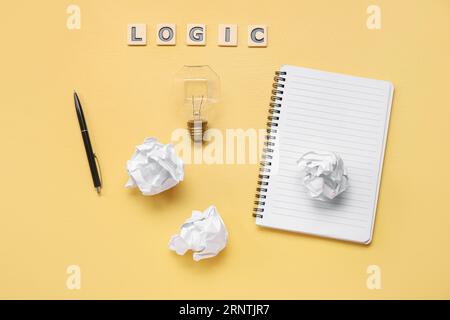 Notebook with word LOGIC, light bulb, pencil and crumpled paper on ...